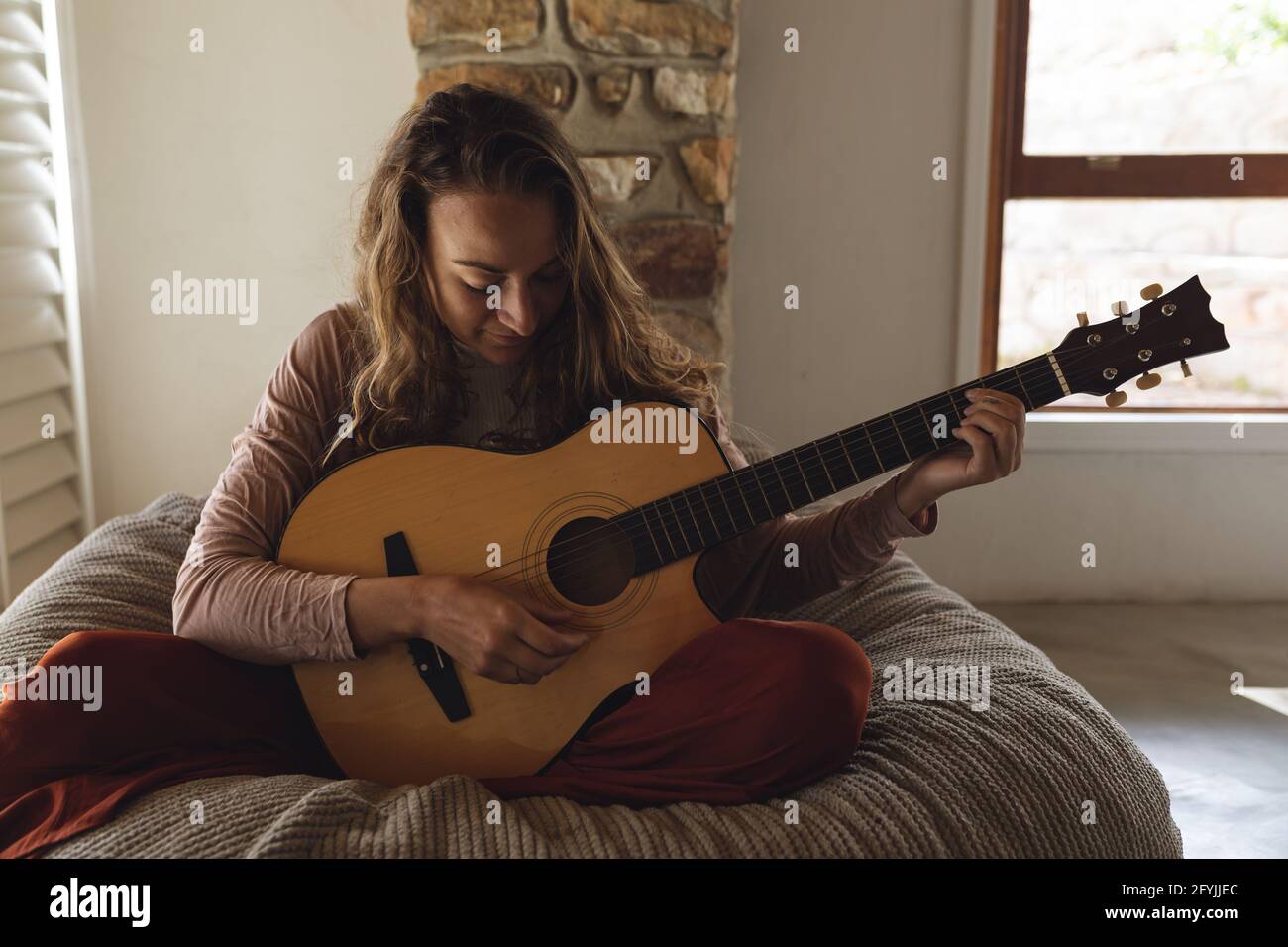 Woman Playing Acoustic Guitar