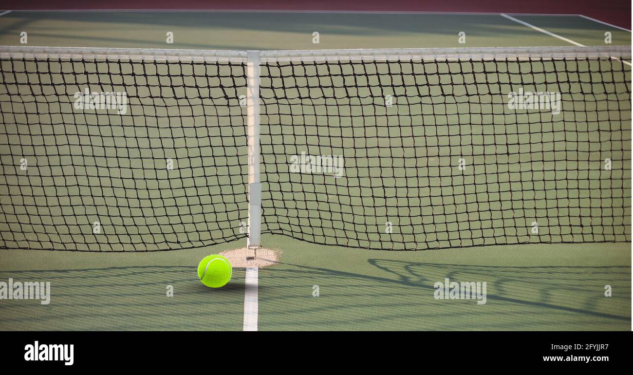 Composition of tennis ball on tennis court with net Stock Photo - Alamy