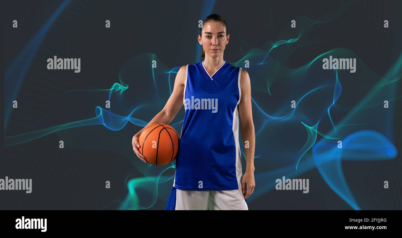 Composition of caucasian female basketball player holding ball on grey ...