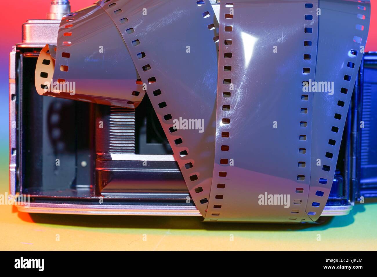 Analogue camera with Film on an colorful background photographed in the ...