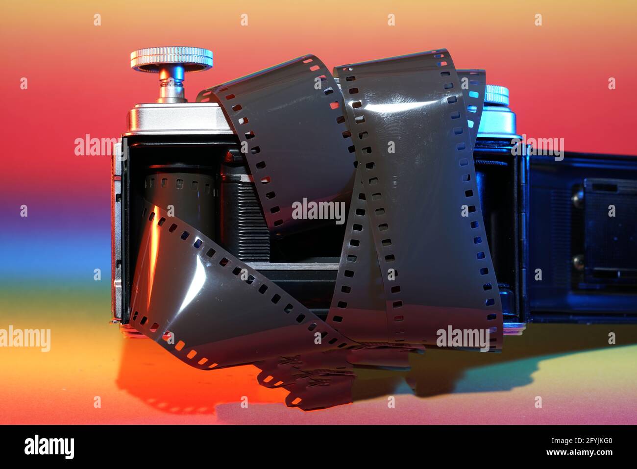 Analogue camera with Film on an colorful background photographed in the ...