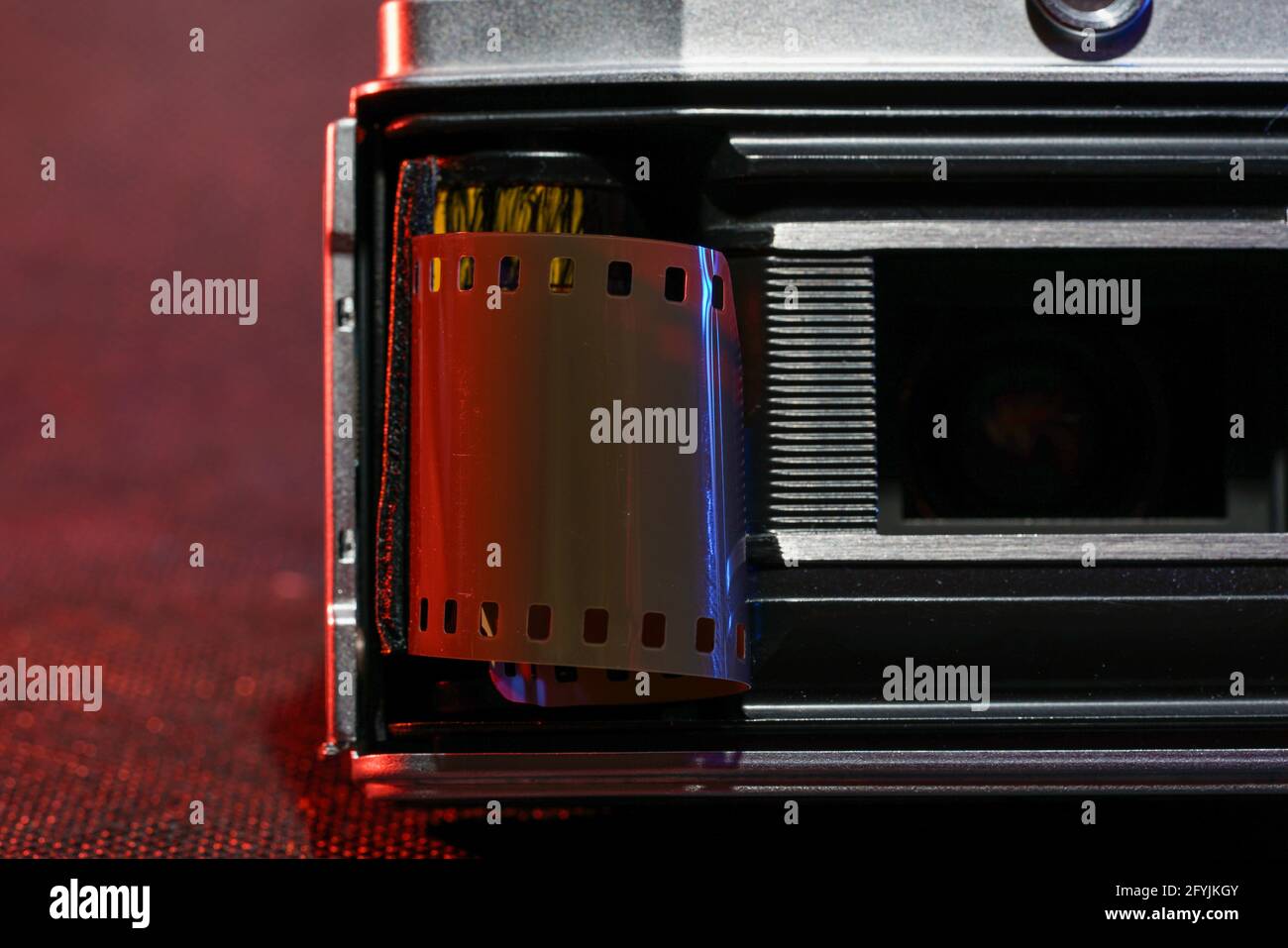 Analogue camera with Film on an colorful background photographed in the ...