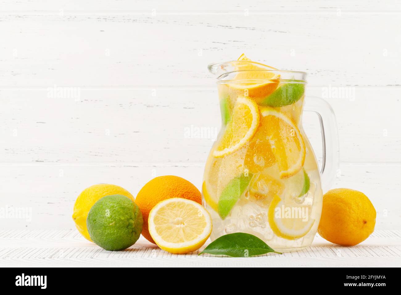 Fresh lemonade glass pitcher with ripe citrus fruits. With copy space ...
