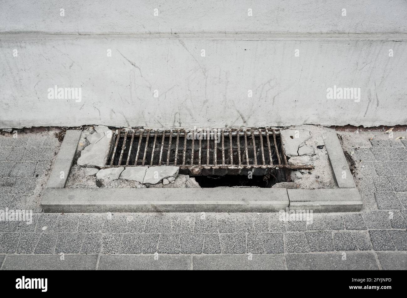 Broken drain grate by wall Stock Photo - Alamy