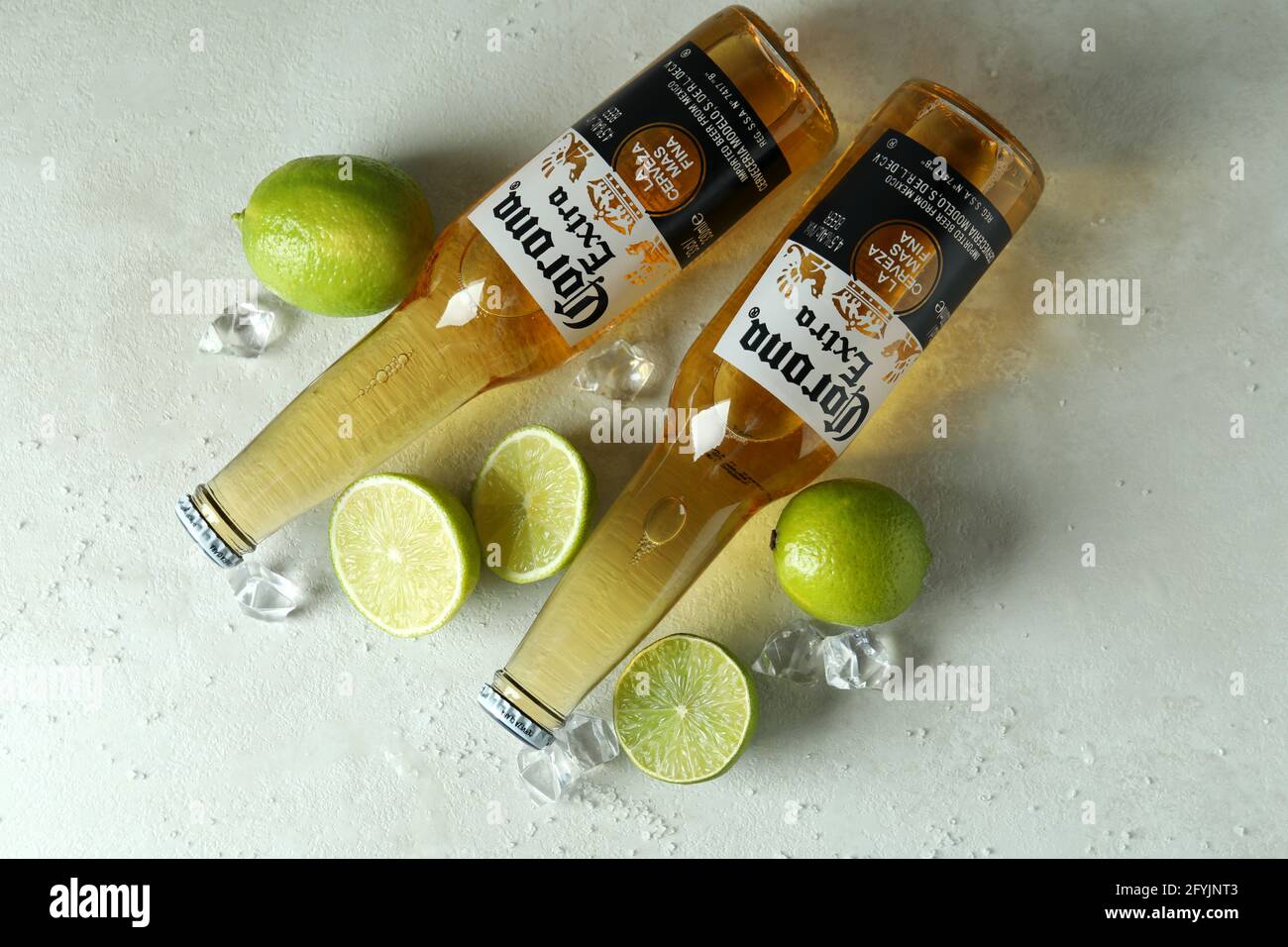 Corona Extra, limes, salt and ice on white textured background Stock ...