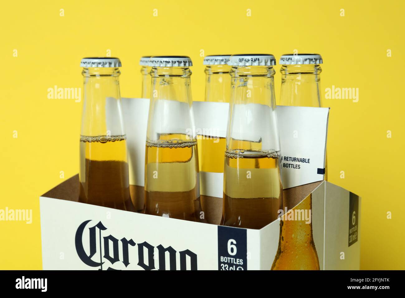 Carton box with Corona Extra on yellow background Stock Photo - Alamy
