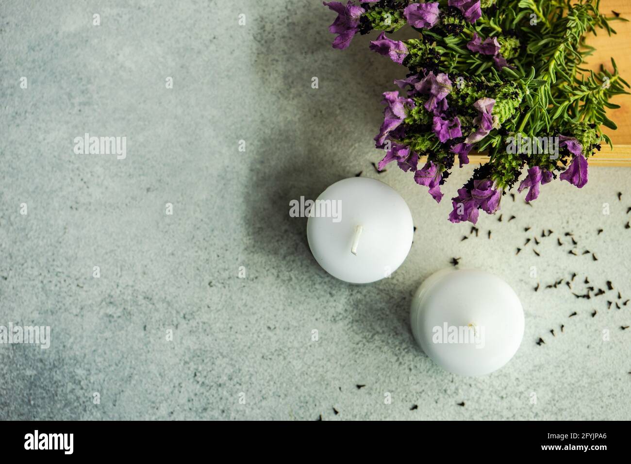 Overhead view of fresh lavender flowers next to two block candles Stock ...