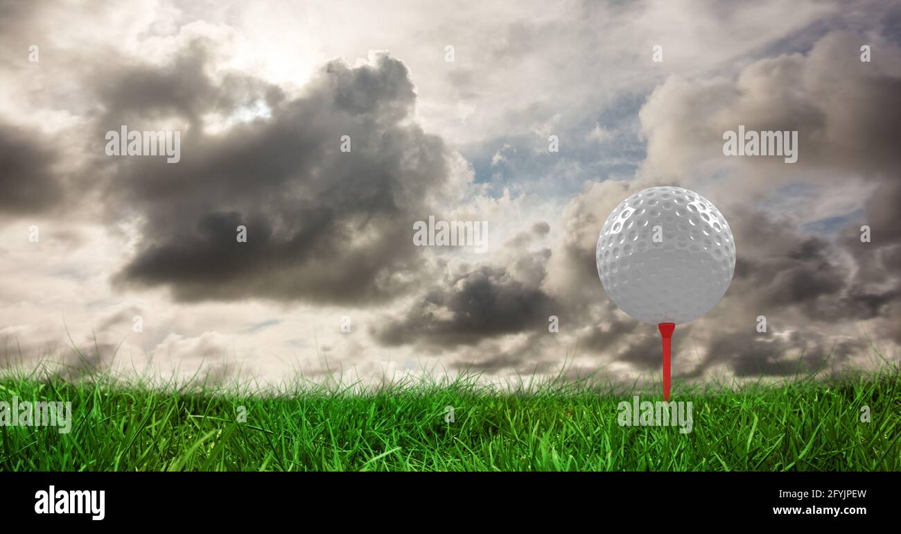 Composition of golf ball in grass on red tee, clouds, and copy space ...