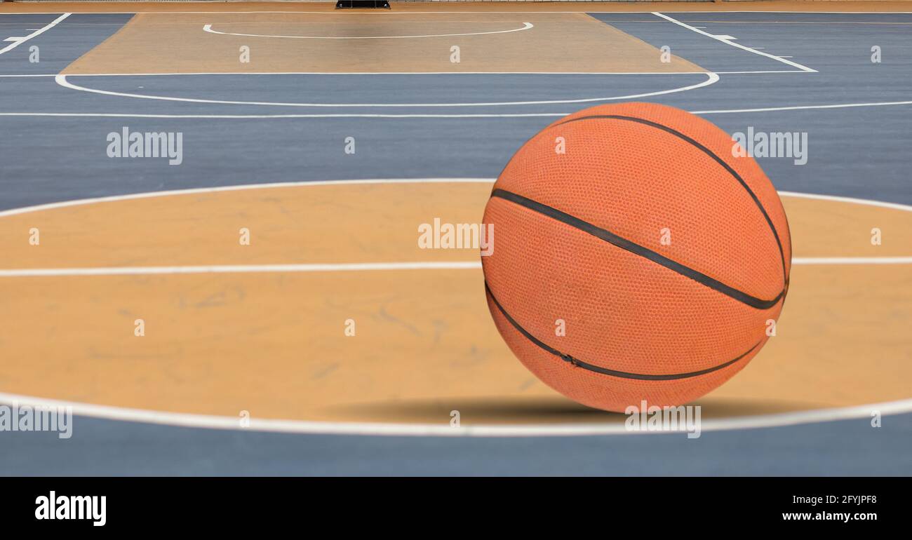 Composition of orange basketball over orange and blue basketball court ...