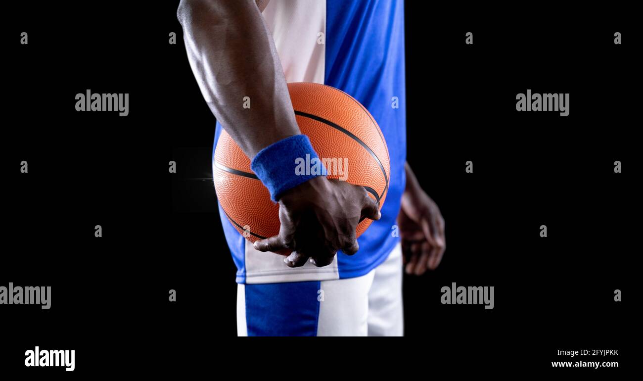 Composition of midsection of male basketball player with ball and copy ...