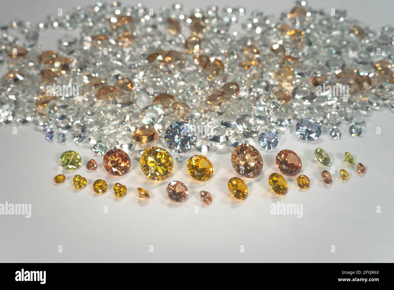 A group of Golden diamonds arranged in a row in front of white diamonds ...