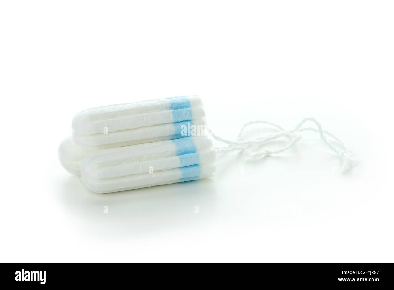 Three unused tampons isolated on white background Stock Photo - Alamy