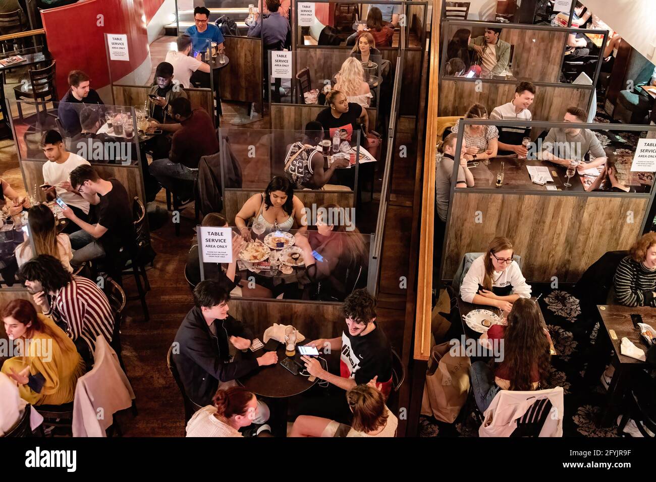 Transparent partitions used to preserve social distance seen inside a ...