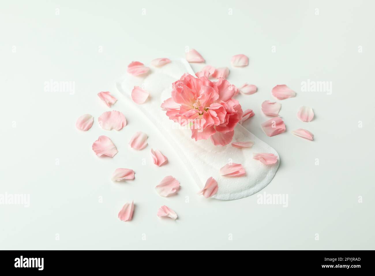 Hygiene pad with flower and petals on white background Stock Photo - Alamy