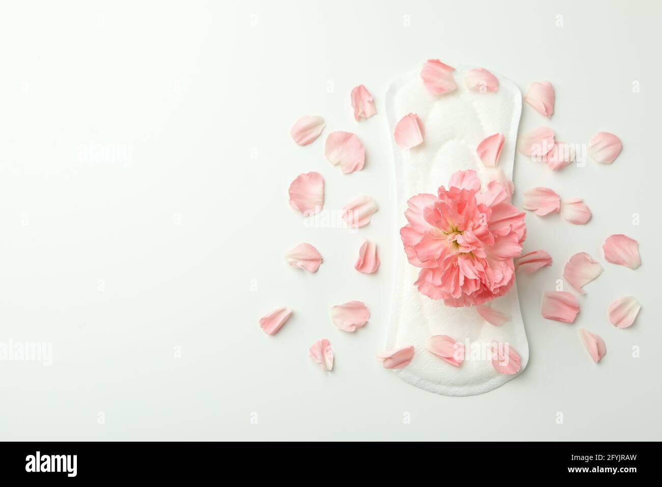 Hygiene pad with flower and petals on white background Stock Photo - Alamy