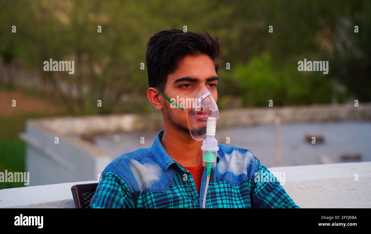 Man infected with Coronavirus disease. Indian patient inhaling oxygen ...