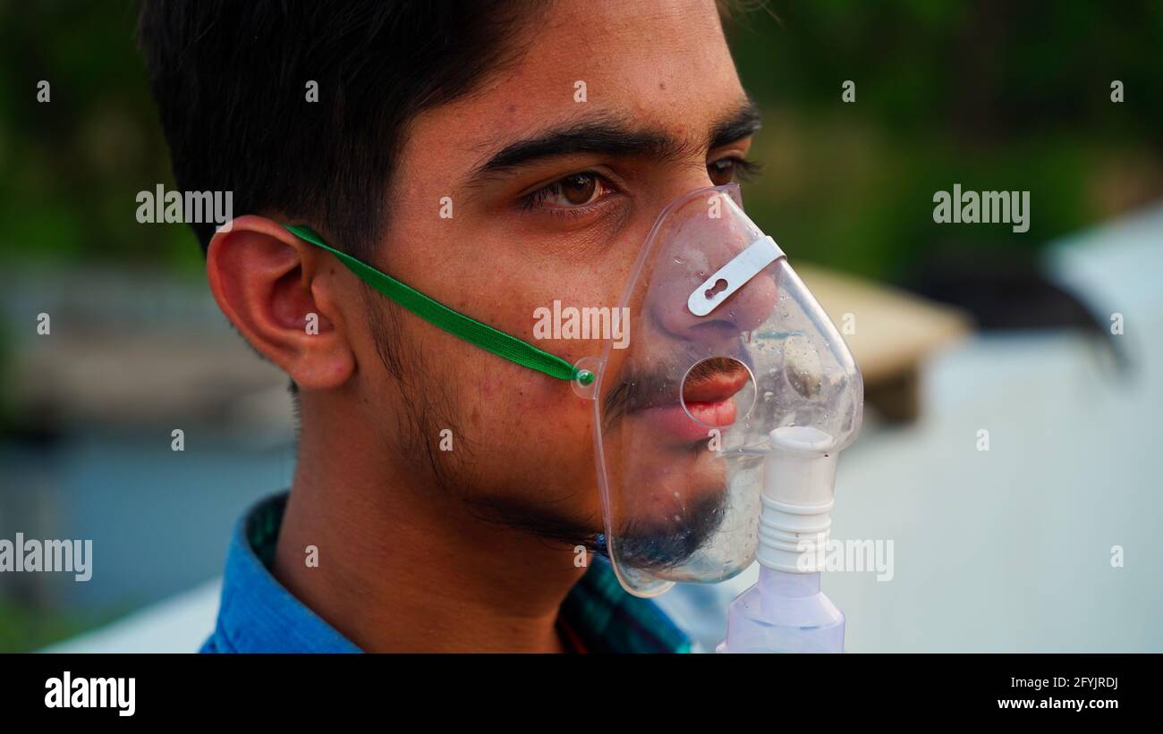 Asian Man infected with Covid 19 disease. Indian Patient breathing ...