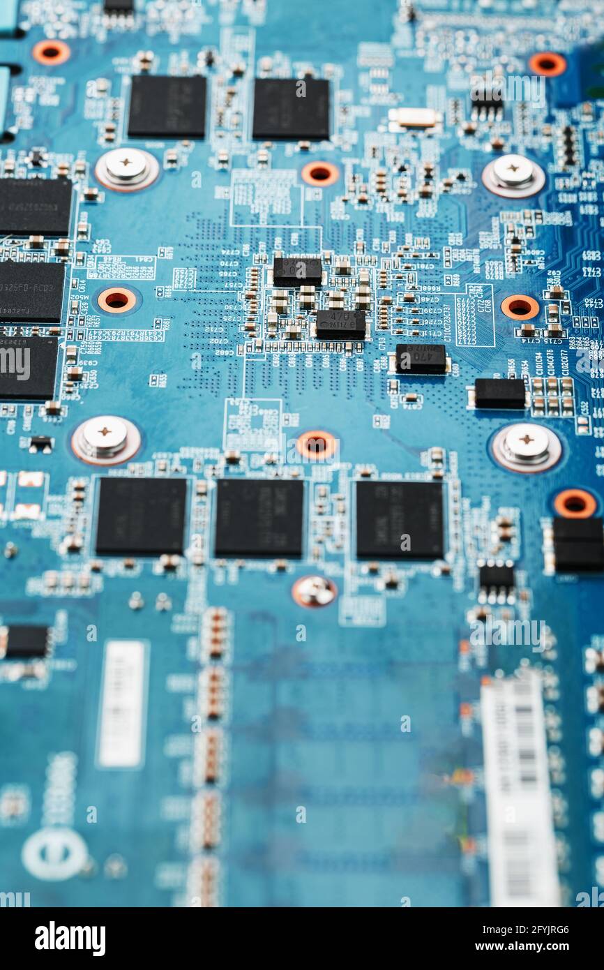 A blue board with chips and a gaming graphics card processor ...