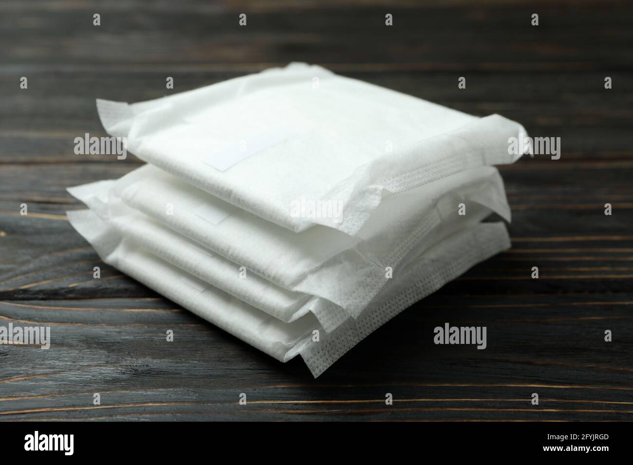 Stack of sanitary pads on wooden background Stock Photo - Alamy