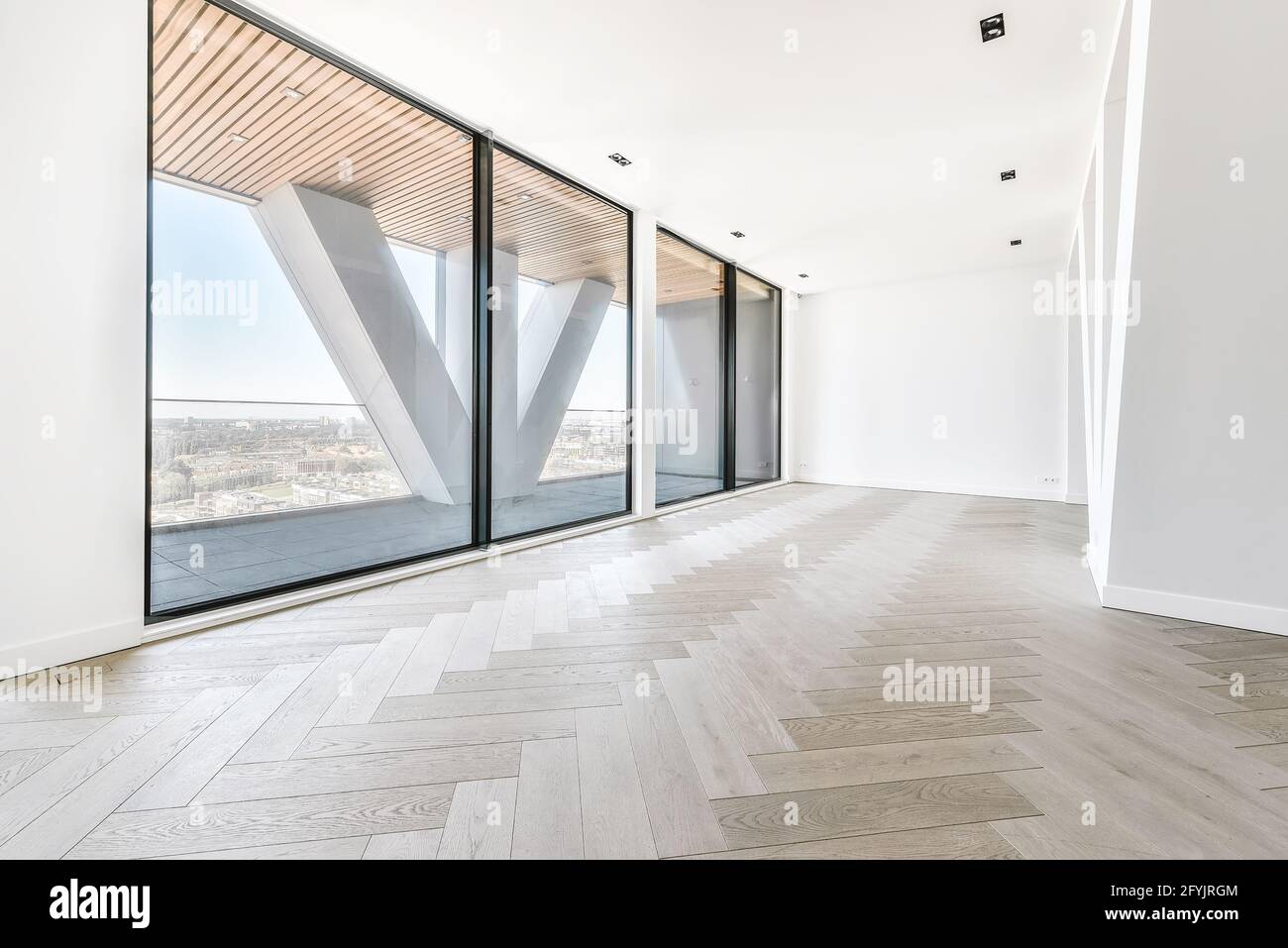 Wall windows with triangle pillar viewing cityscape from luxury ...