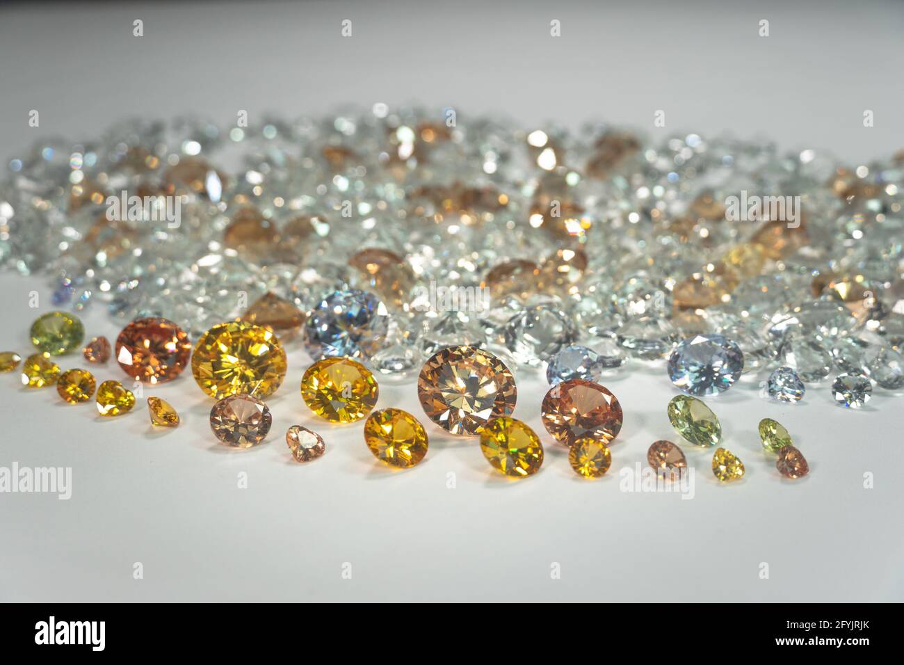 A group of Golden diamonds arranged in a row in front of white diamonds ...