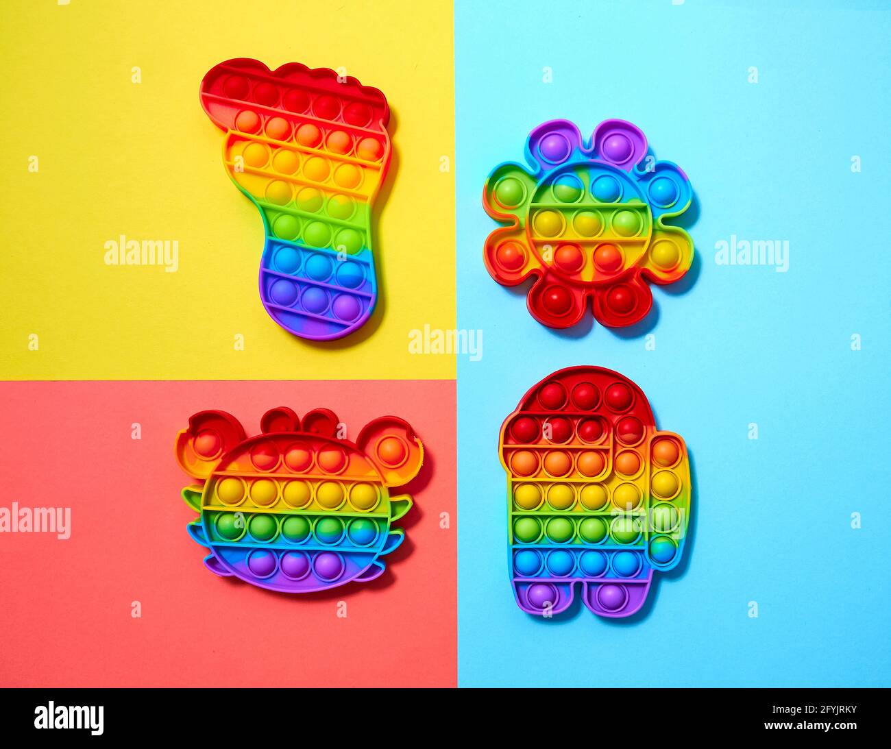 Trendy pop it toys in form of foot, crab, flower, and a character among ...