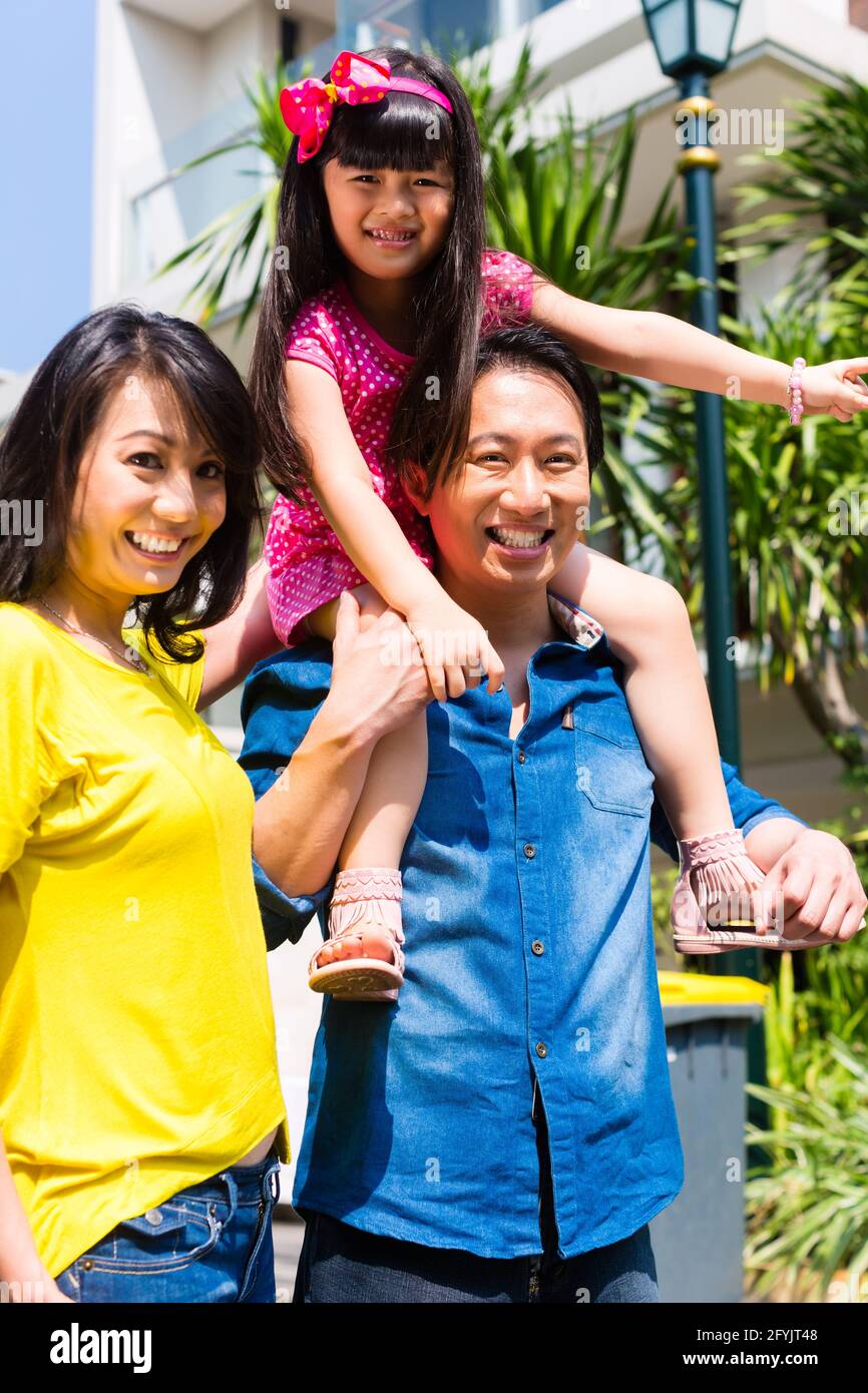 Asian Chinese family of parents and child standing proud in front of ...