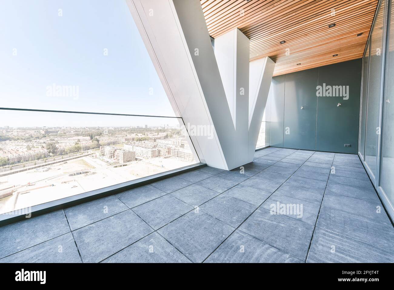 Balcony of luxury apartment in high rise building with glass fence and ...