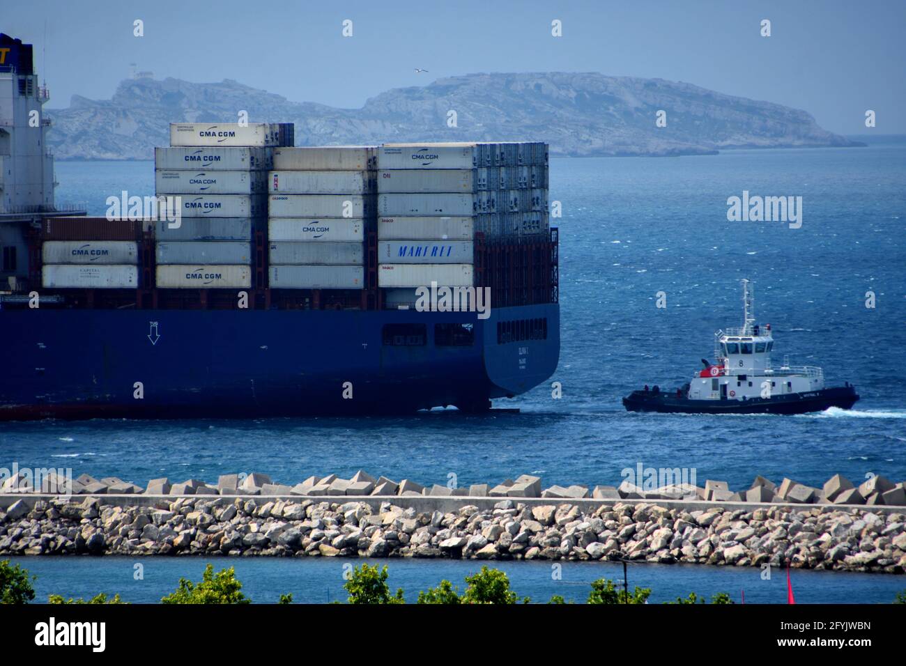 The container ship CMA CGM "Olivia I" guided by a tugboat, on arrival ...