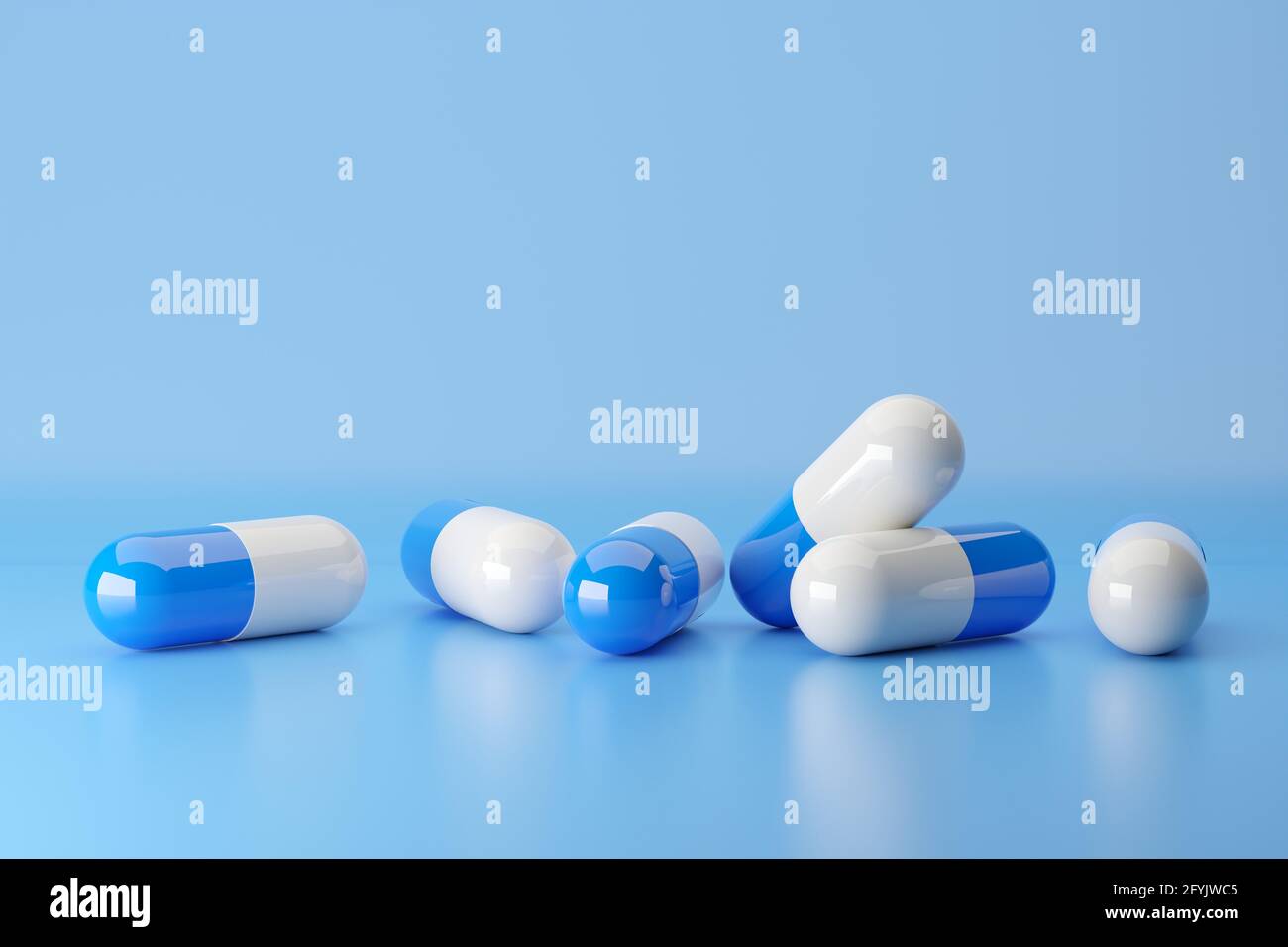 Blue and white pill capsules over blue background, medical treatment ...