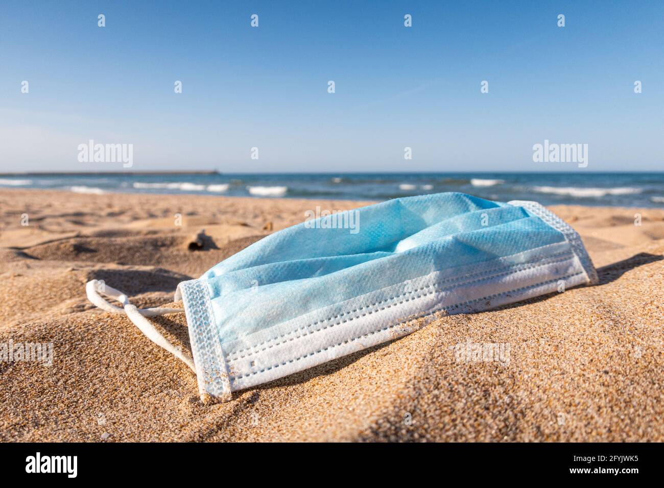 Closeup shot of a face mask on the sand on the beach Stock Photo - Alamy