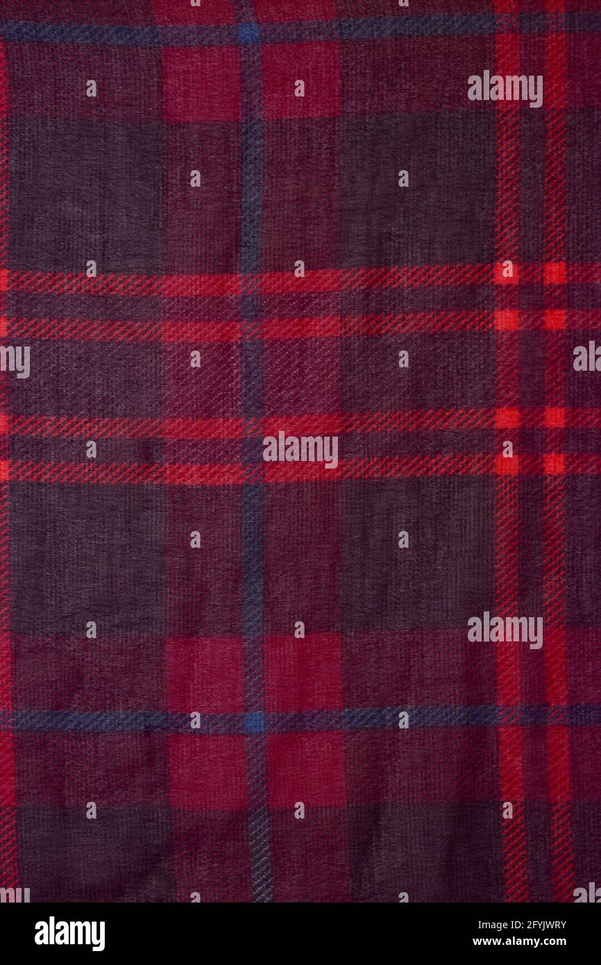 Vertical shot of red checkered fabric used for wallpaper or background ...