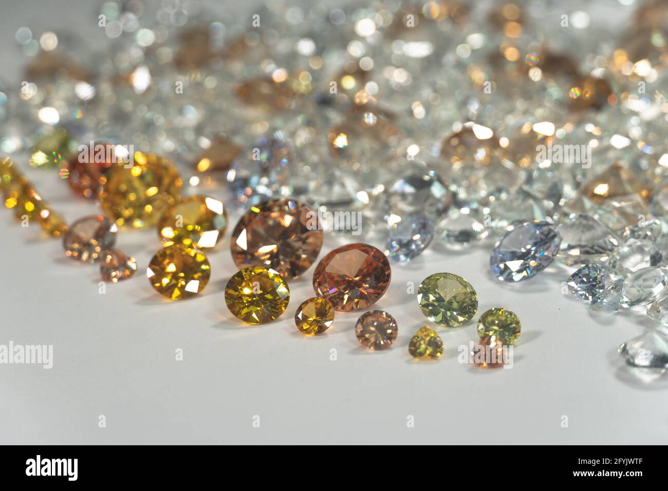 A group of Golden diamonds arranged in a row in front of white diamonds ...