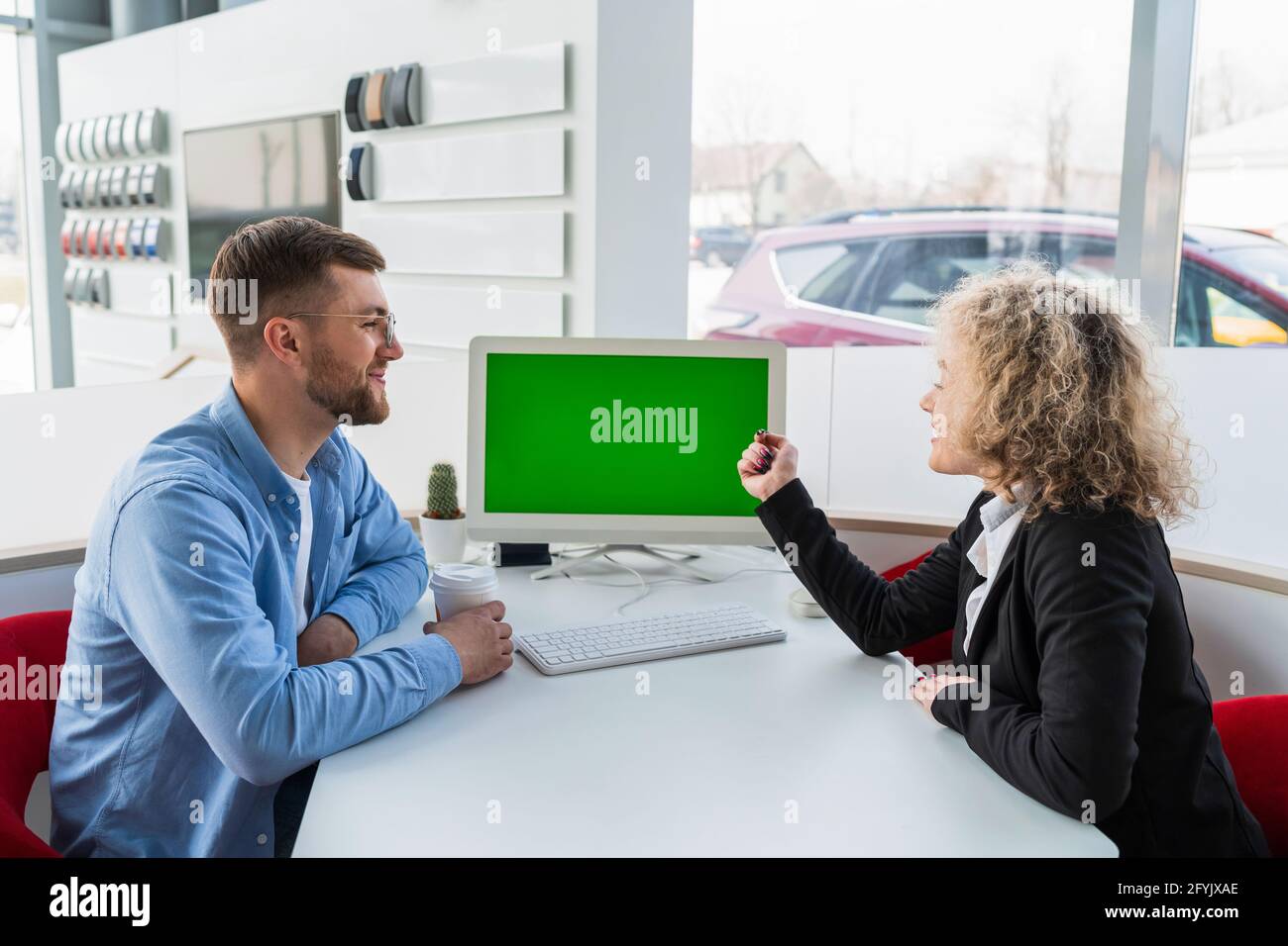 Car sales manager with client at computer in dealership Stock Photo - Alamy
