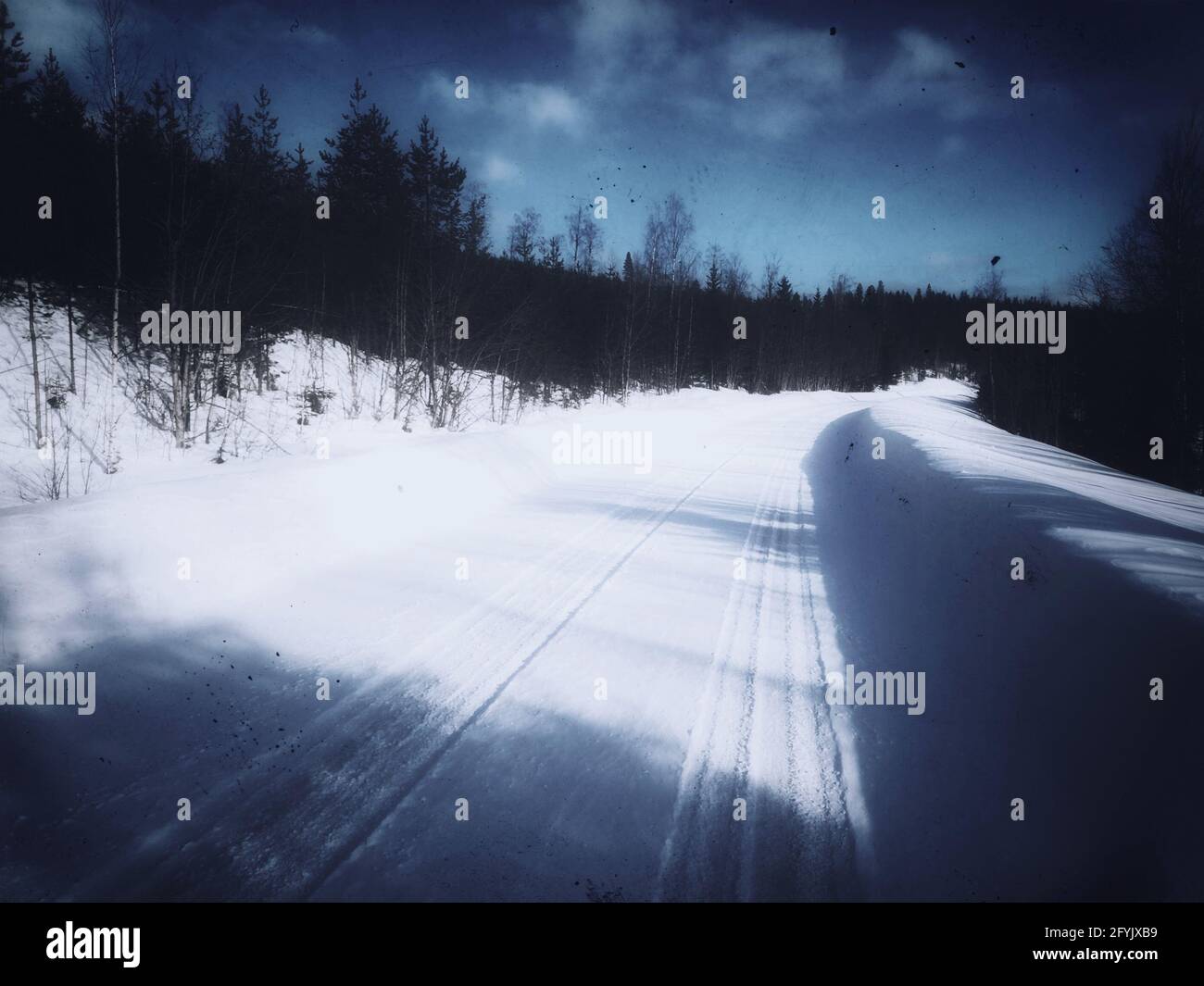 Winter road with wheel tracks in Vasterbotten, northern Sweden Stock ...