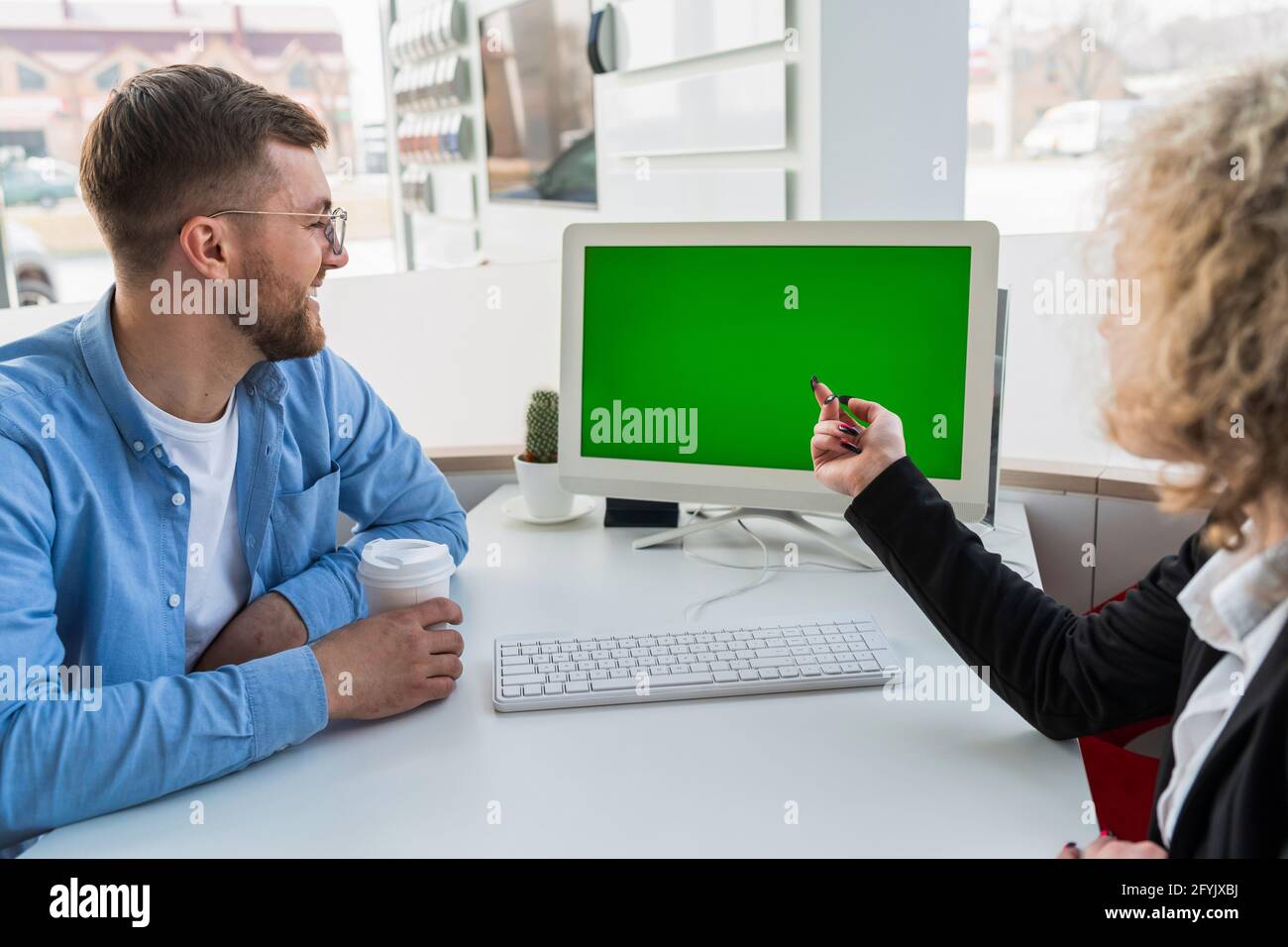 Car sales manager with client at computer in dealership Stock Photo - Alamy