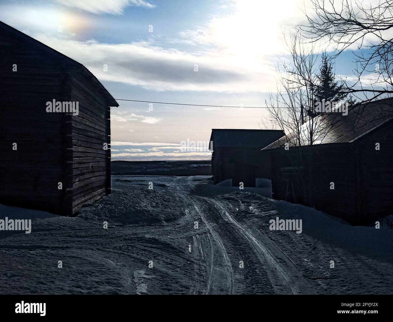 Old farm buildings in winter, backlit by the sun Stock Photo - Alamy