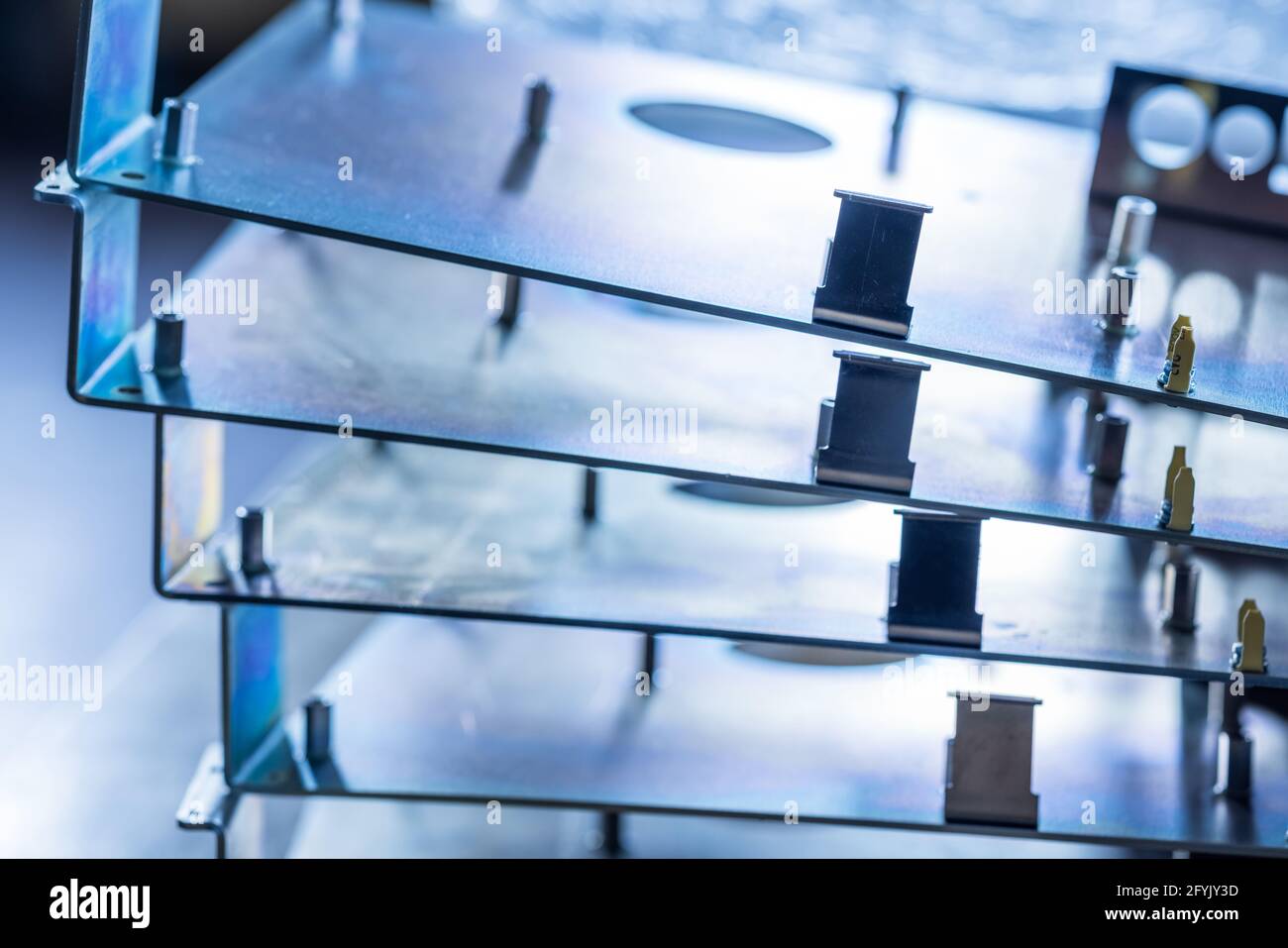 Metal boards and accessories lie on the surface during the production ...