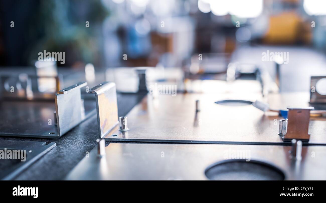 Metal boards and accessories lie on the surface during the production ...