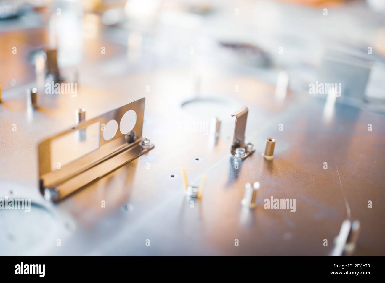 Metal boards and accessories lie on the surface during the production ...