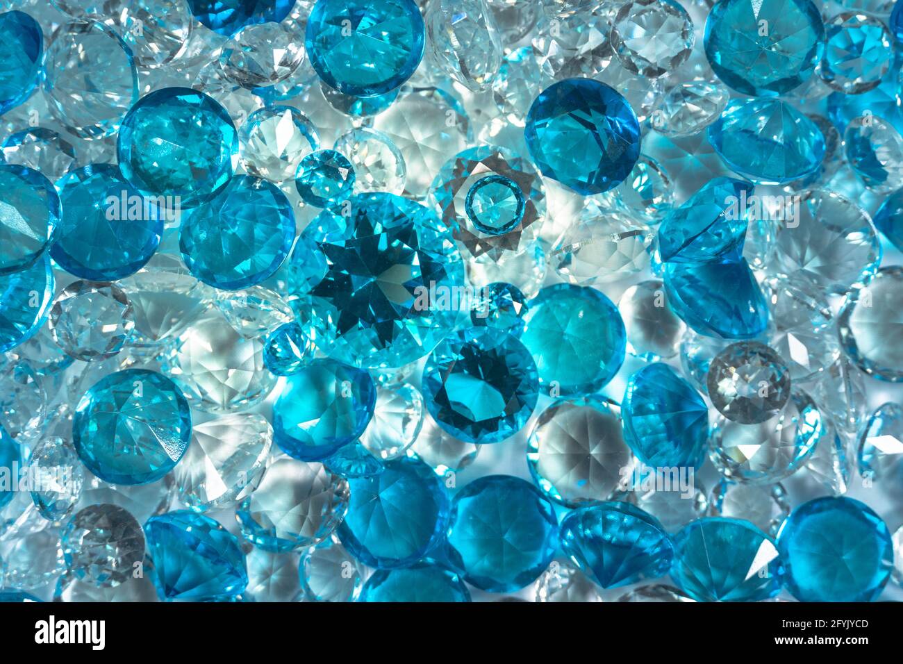 A group of aquamarine blue diamonds arranged in the middle of white ...
