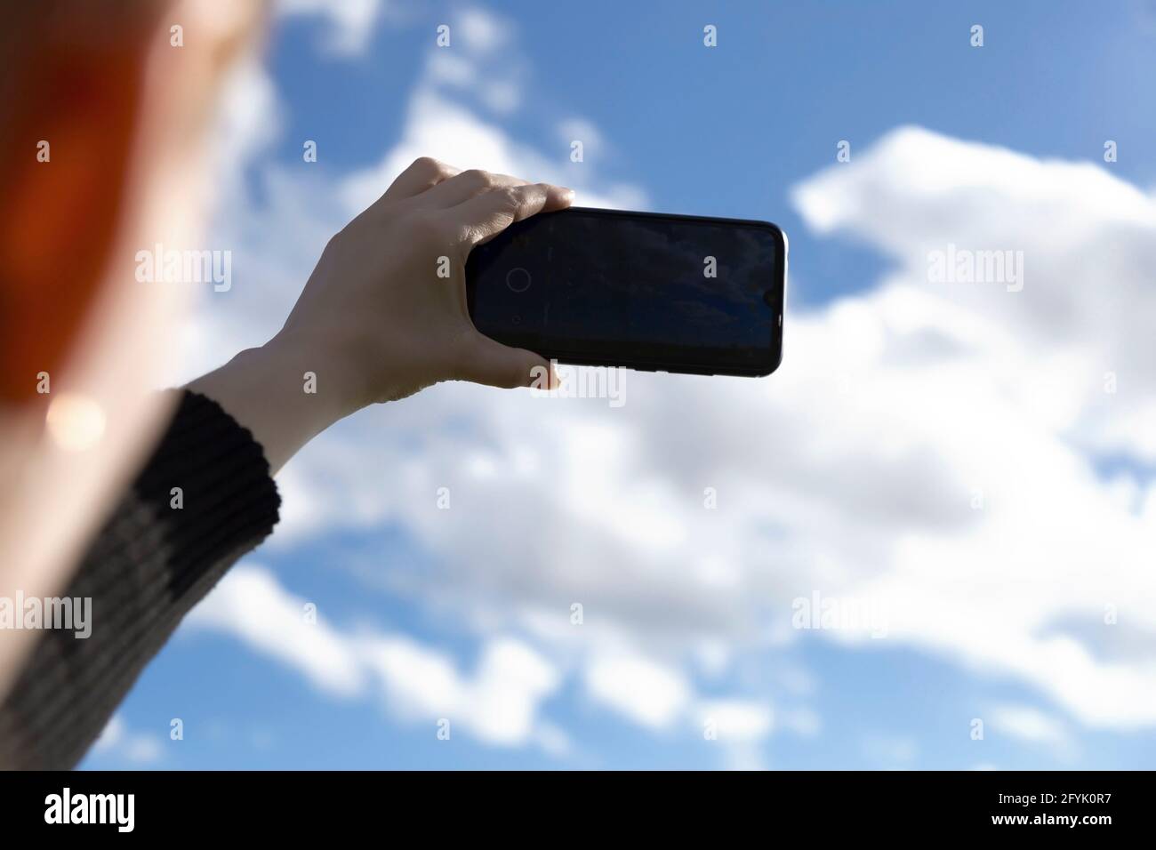 Woman photographs nature scenery on smartphone. Close up of defocused ...