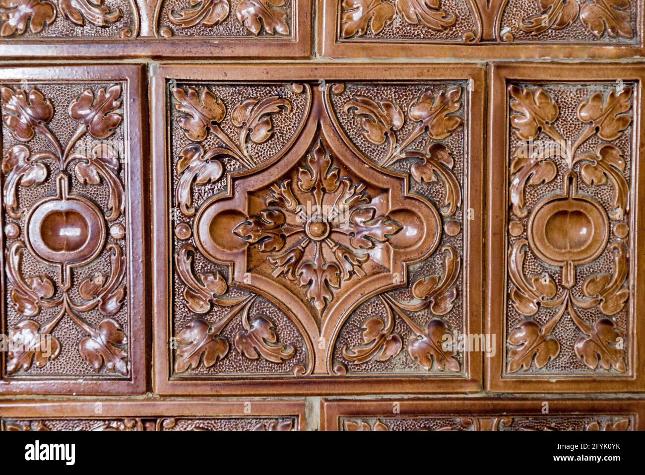 texture, backgrounds brown ceramic tiles on a stove for heating. Close ...
