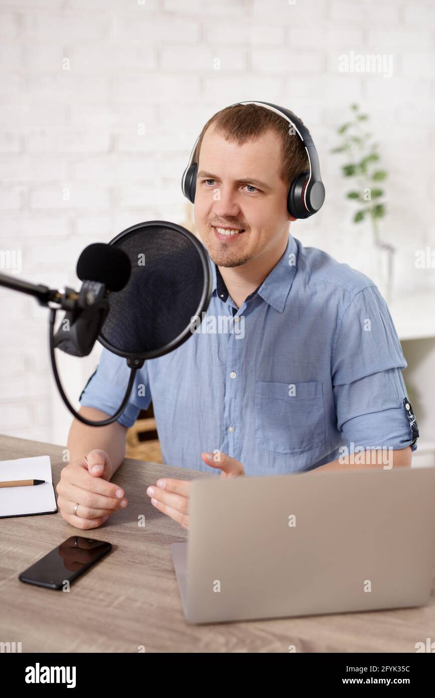 journalism, radio, podcast and blogging concept - handsome man talking ...