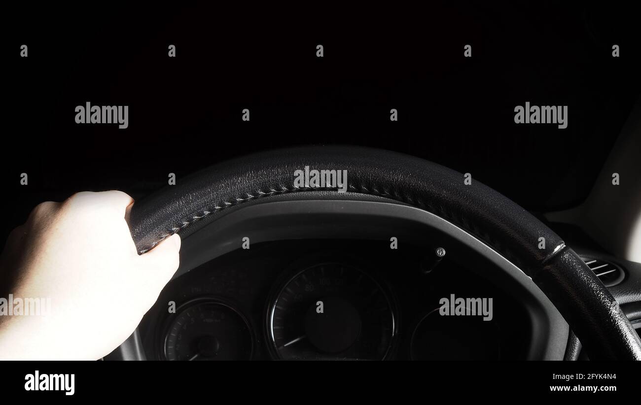 Steering wheel and man hand. Black leather modern car Interior close up ...