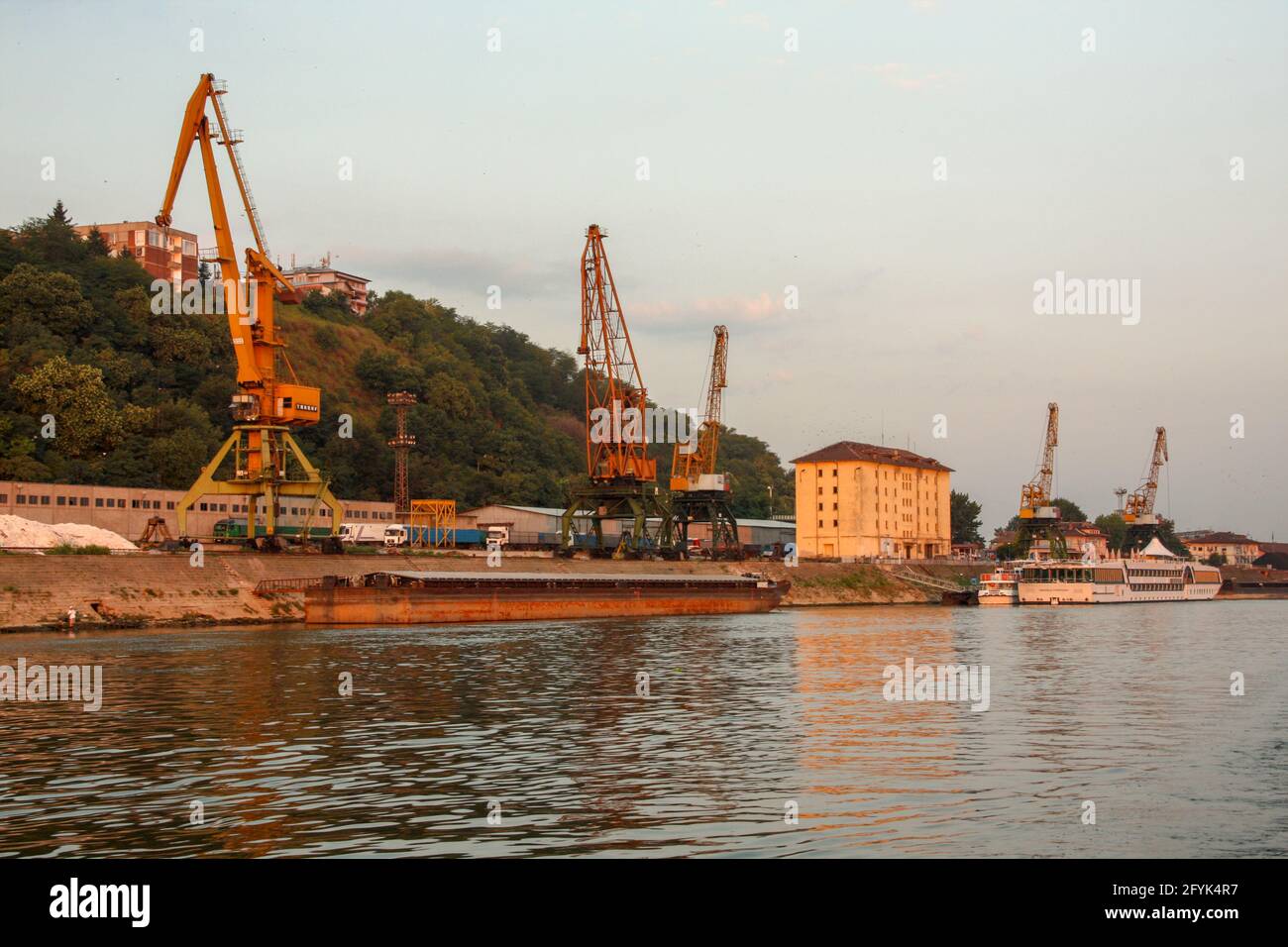 Construction cranes in port of Svishtov by Danube river, Bulgaria Stock ...