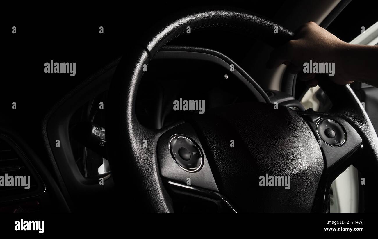 Steering wheel and man hand. Black leather modern car Interior close up ...