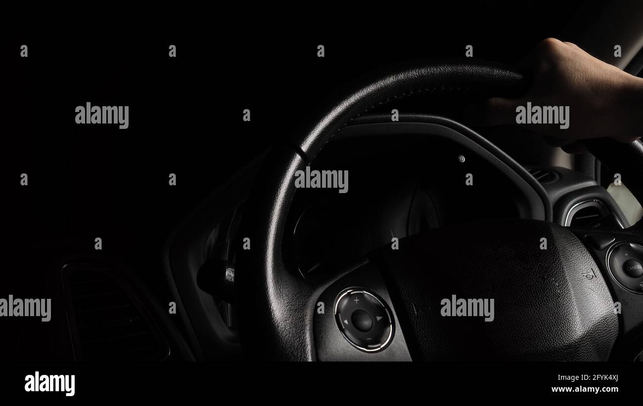 Steering wheel and man hand. Black leather modern car Interior close up ...