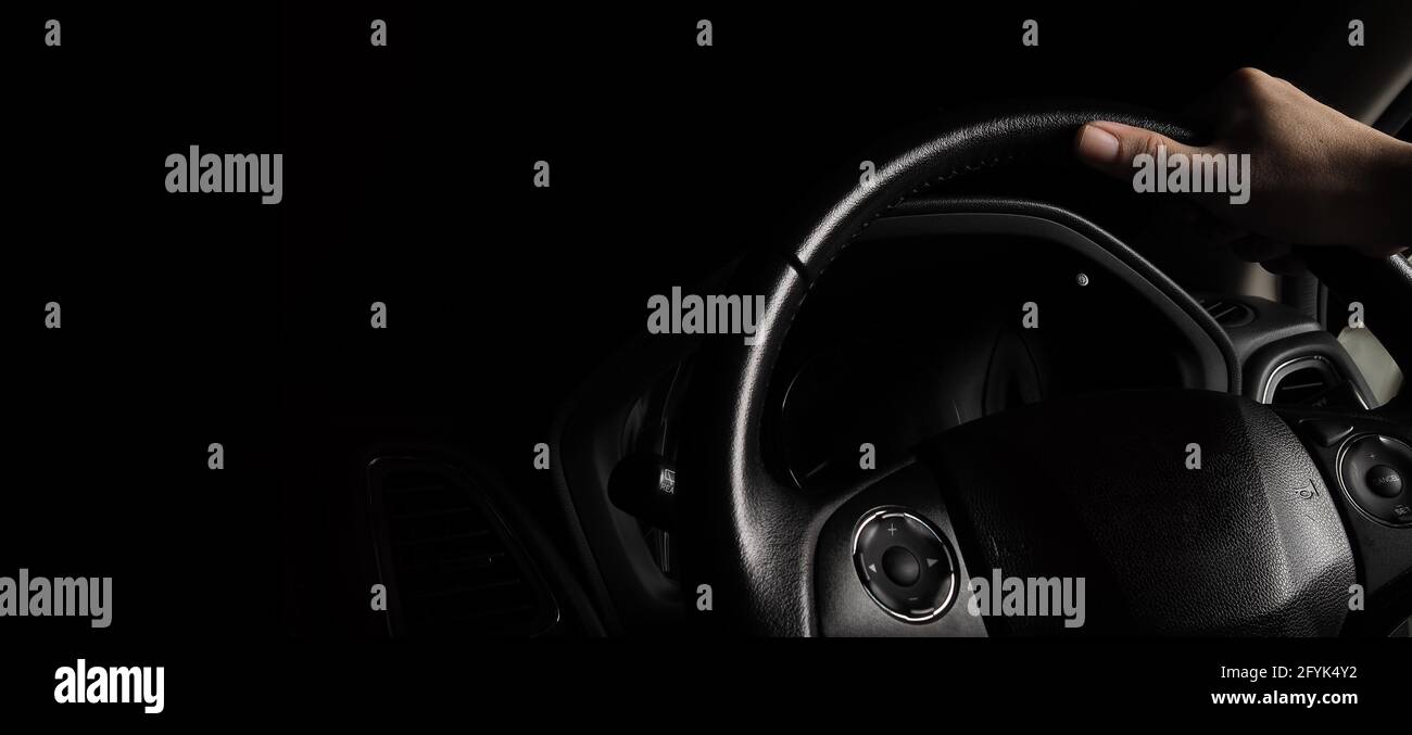 Steering wheel and man hand. Black leather modern car Interior close up ...