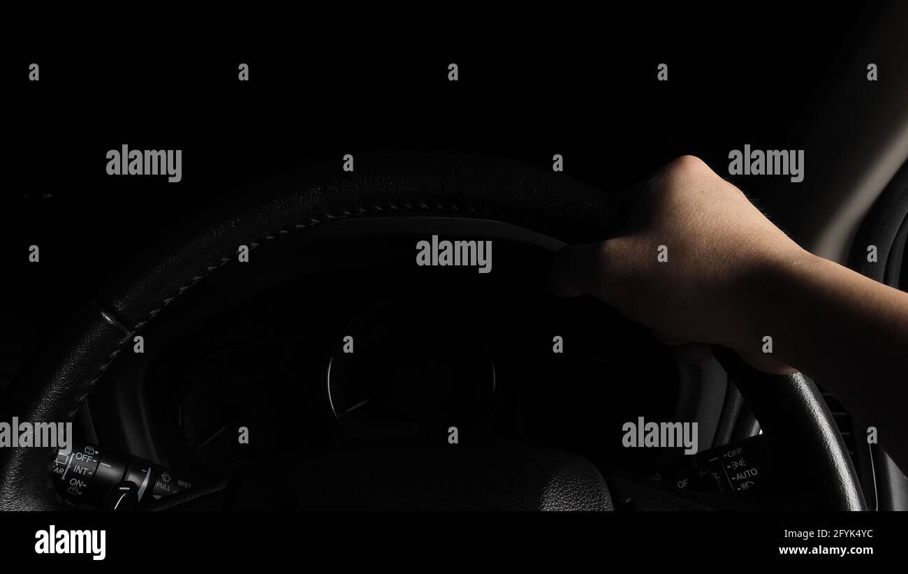 Steering wheel and man hand. Black leather modern car Interior close up ...